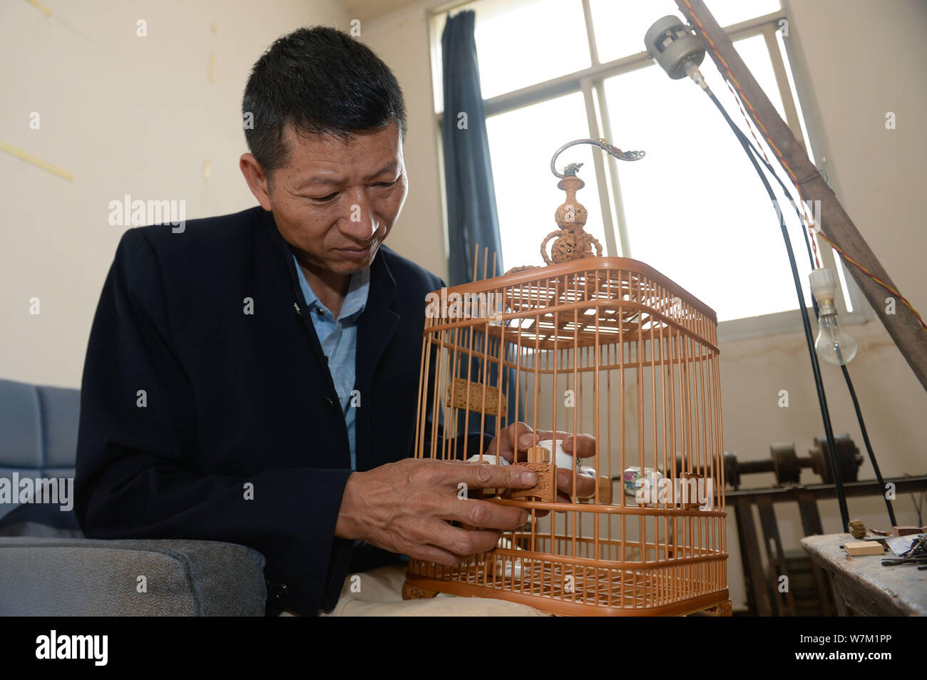 Chinese birdcage making master Yangchun makes the artwork of a birdcage ...