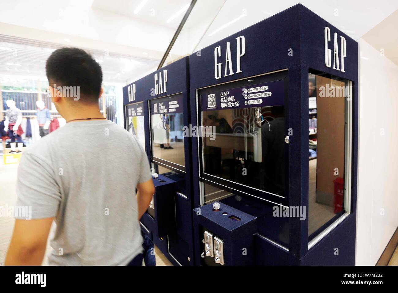 A customer walks past toy grabber machines at the China's largest Gap ...