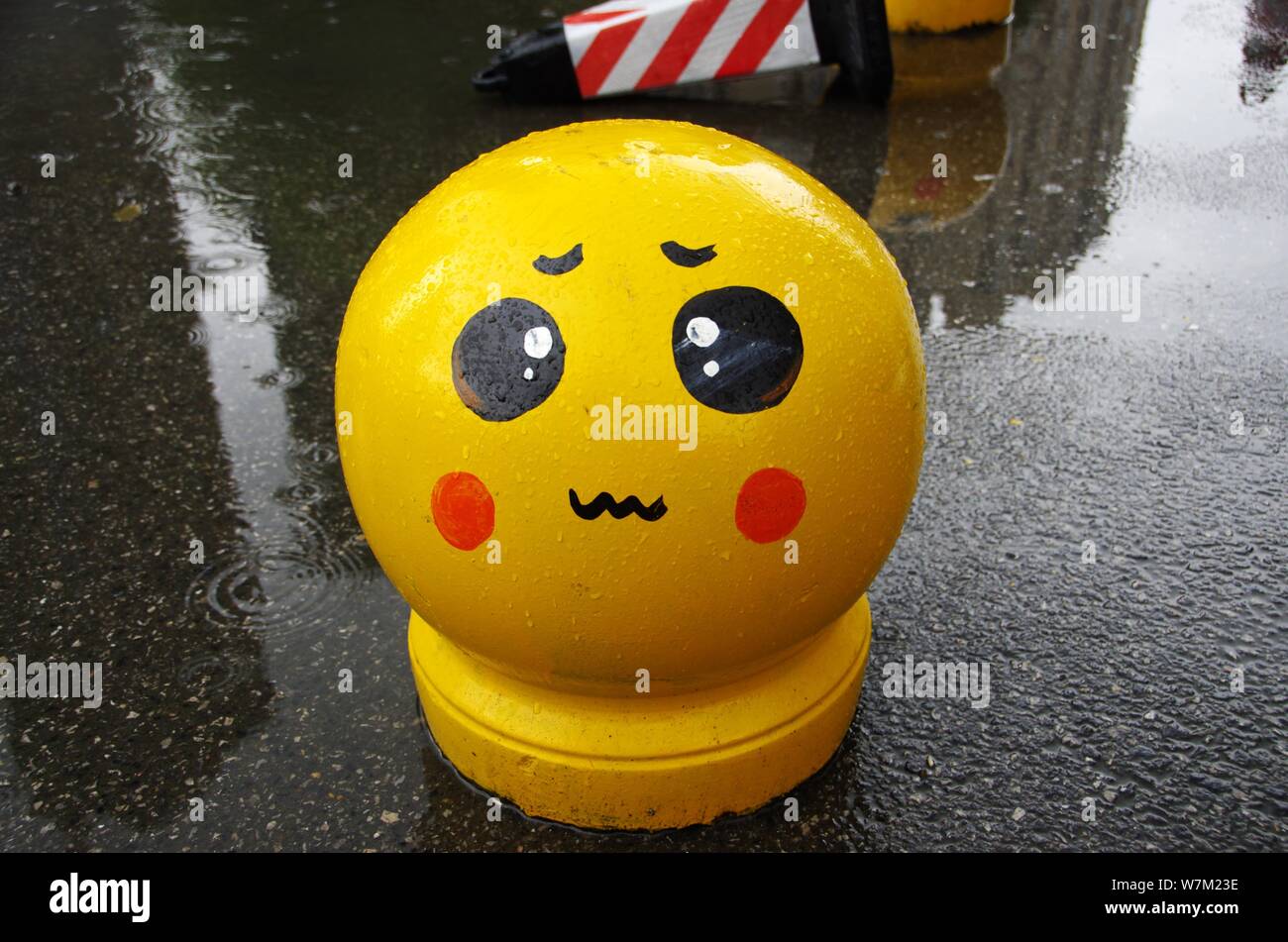 View of a emoji stone block set up to regulate the parking order at a ...