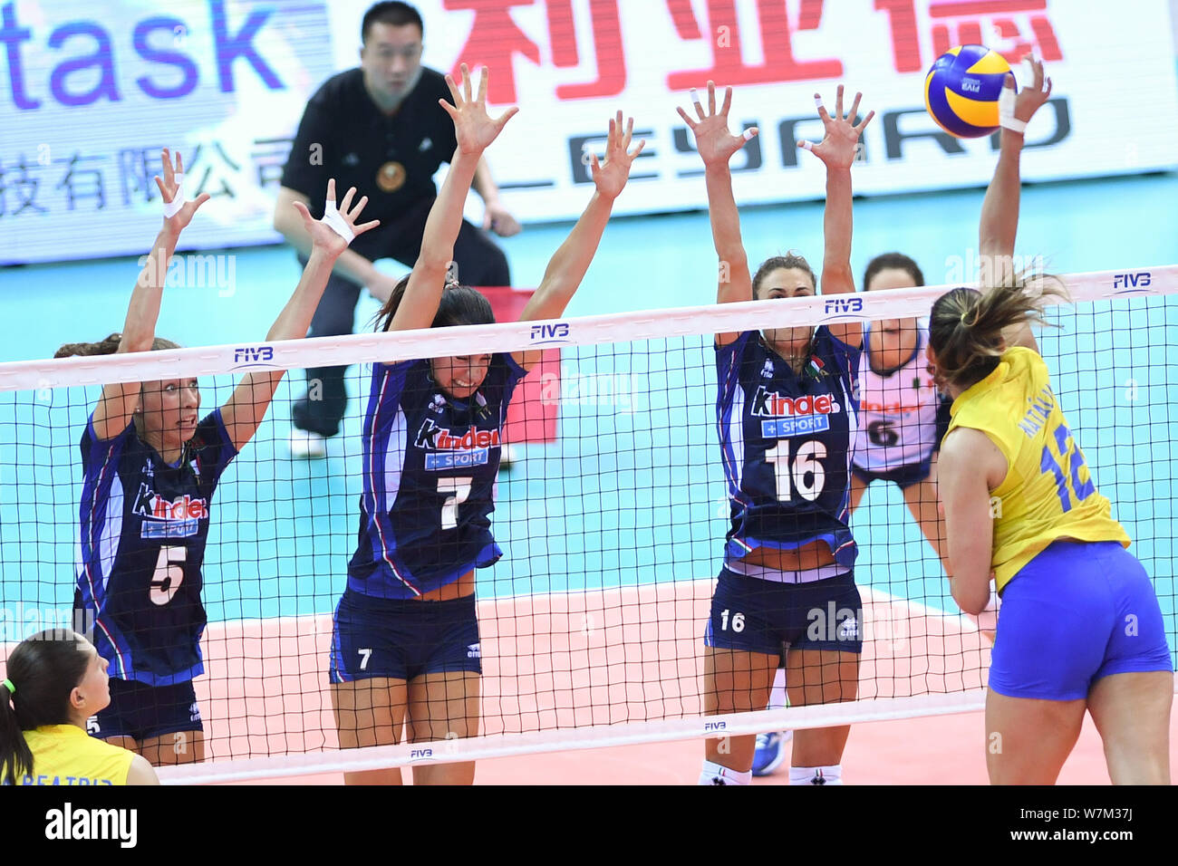 (From right) Natalia Pereira of Brazil spikes against Lucia Bosetti ...