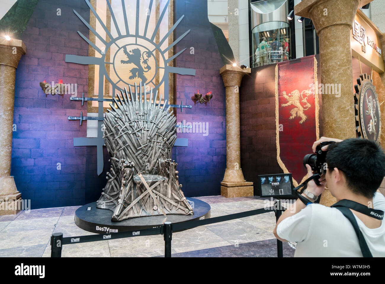 A visitor takes photos of a life size replica of the Iron Throne from ...
