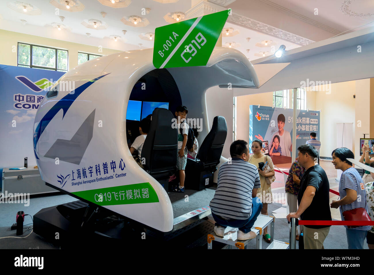 Visitors queue up to try out a flight simulator of China's first large ...