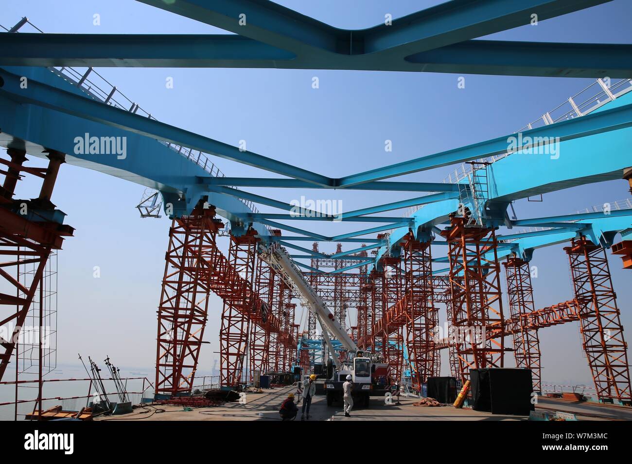 Chinese workers labor at the construction site of the world's longest ...