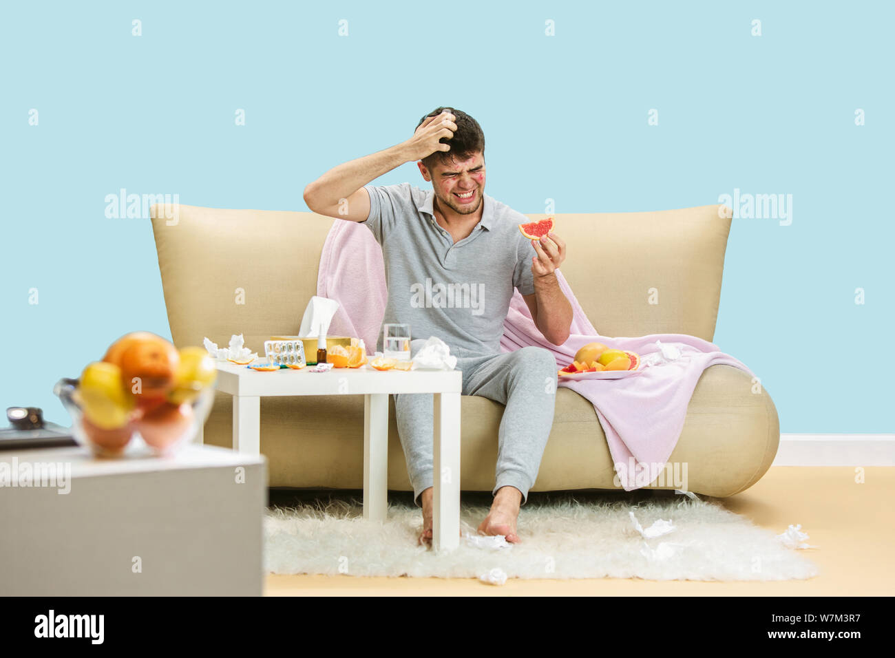 Young man suffering from allergy to citrus fruits. Having skin rash ...