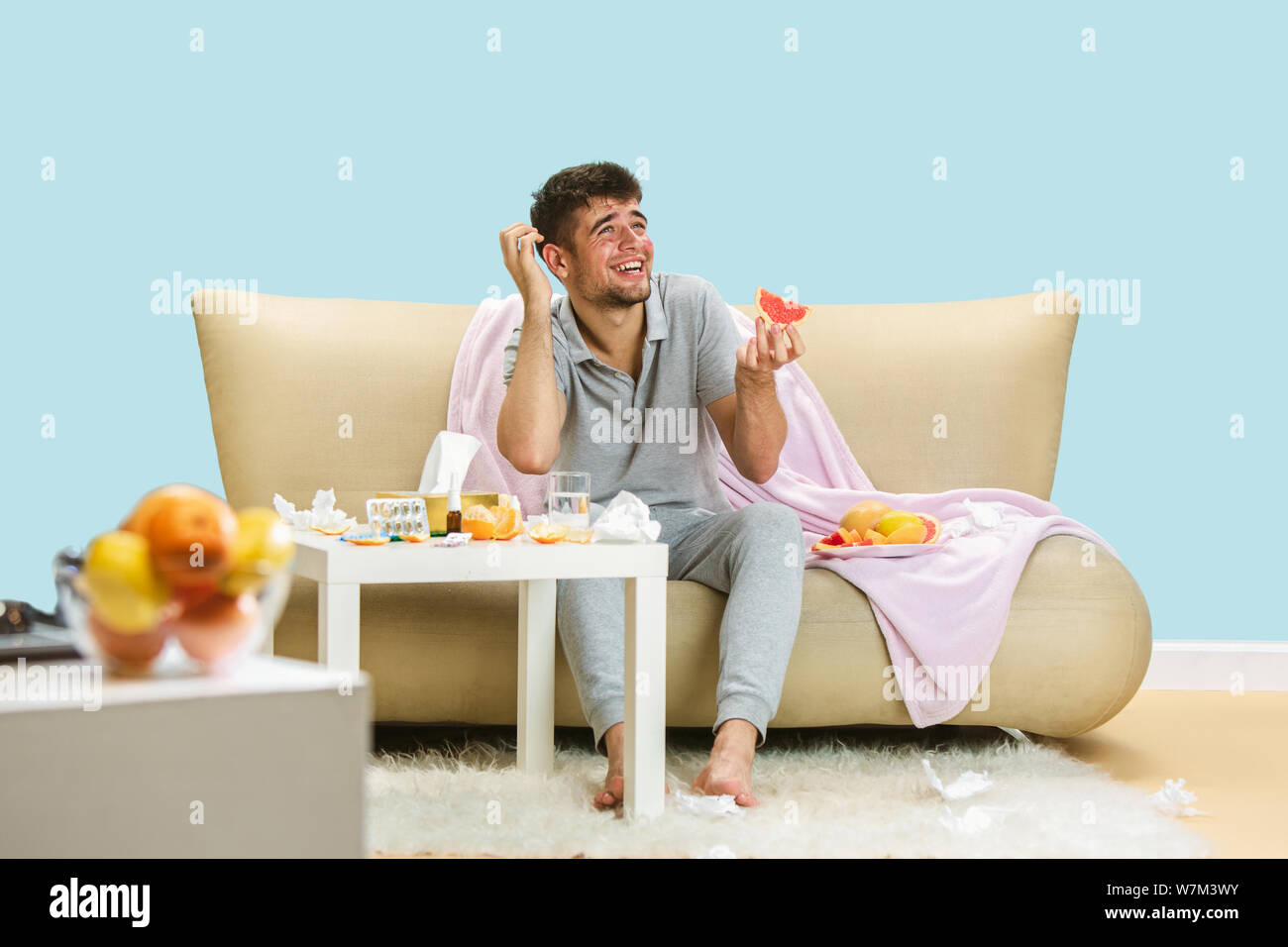 Young man suffering from allergy to citrus fruits. Having skin rash ...