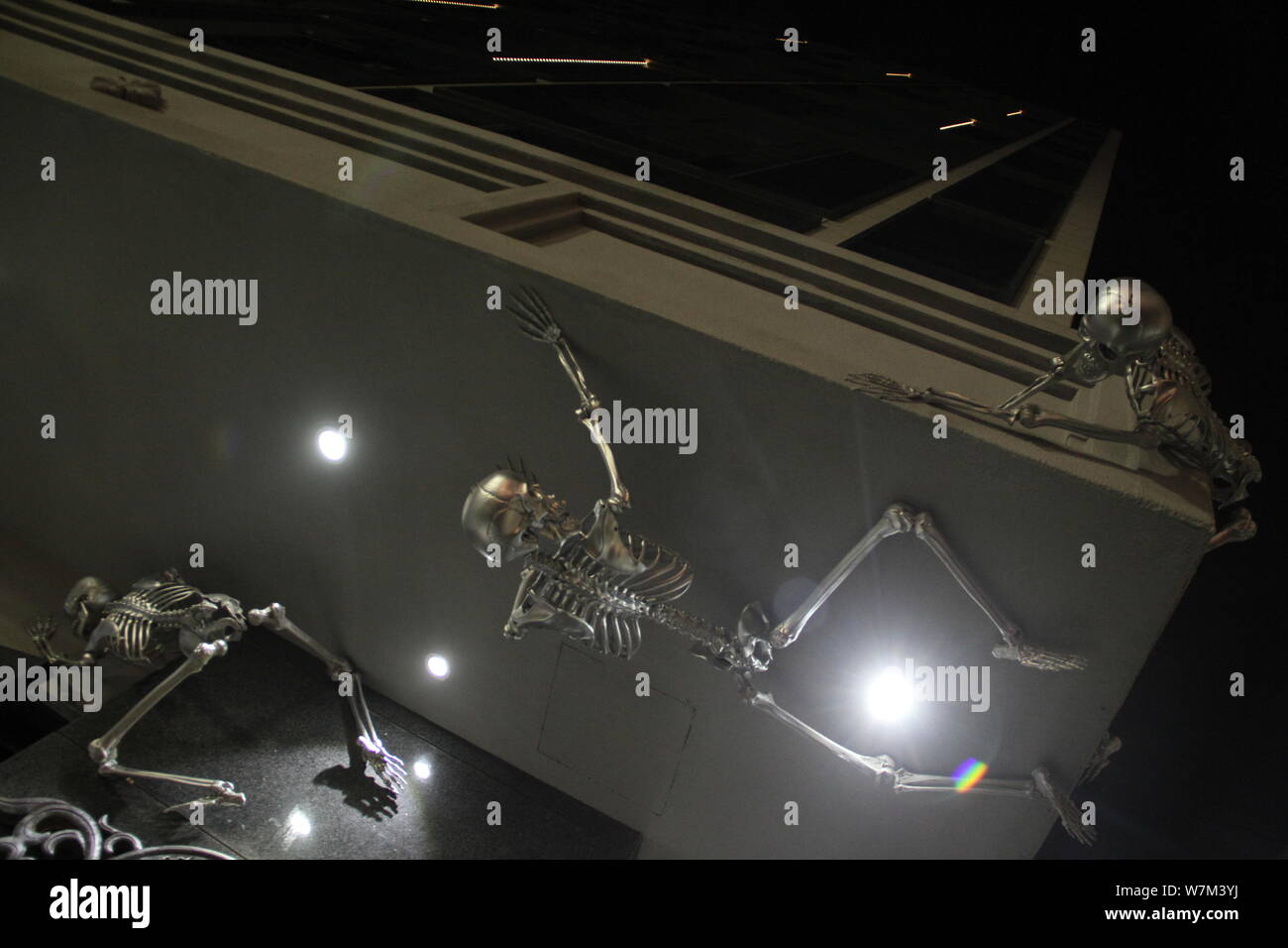 Skeleton sculptures climb a shopping mall to attract customers in Ji ...