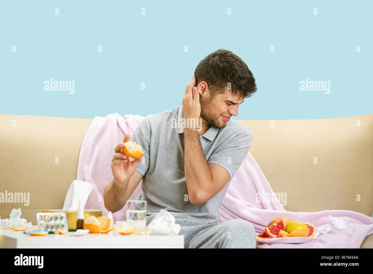 Young man suffering from allergy to citrus fruits. Having skin rash ...