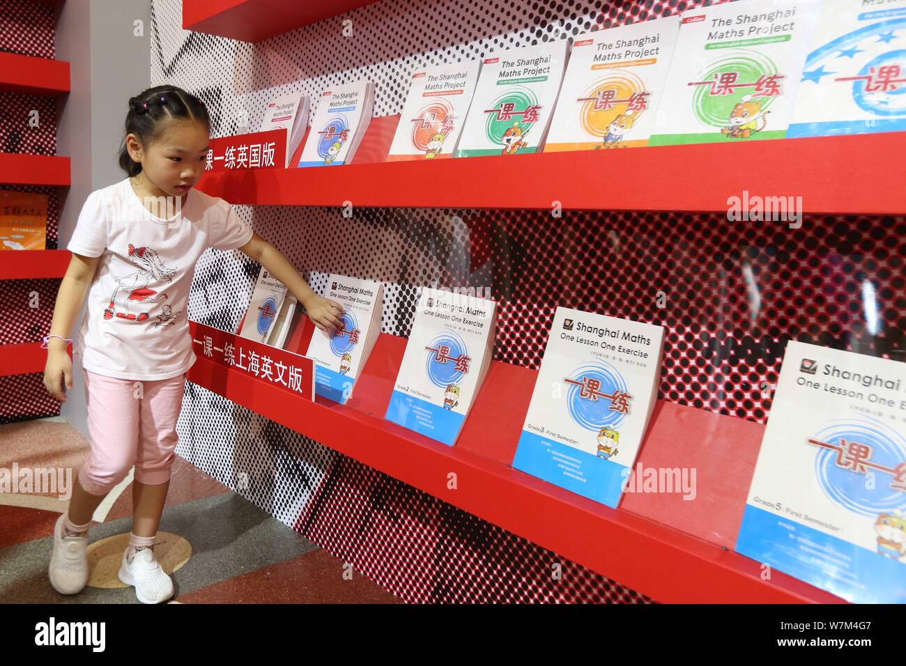 A pupil looks at the UK version, upper, and the English version of the ...
