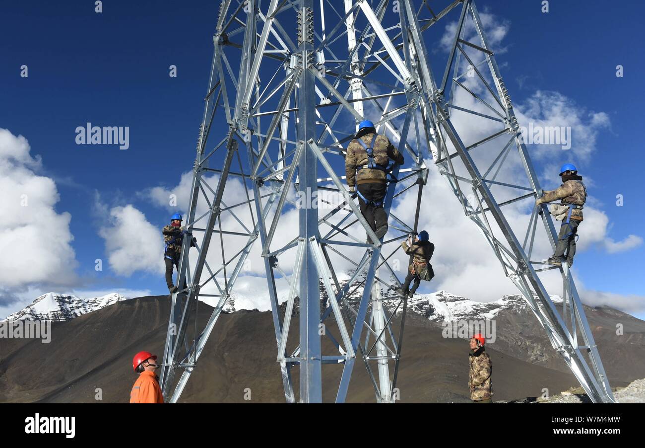 Electricity workers are assembling the highest power transmission tower in the world with a ...