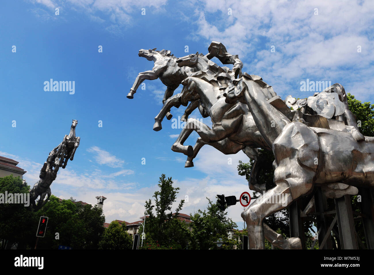 An artwork of "horses" piled up to form the shape of an arch door is ...
