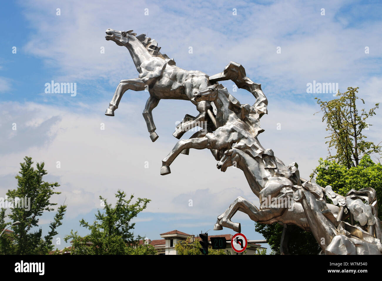 An artwork of "horses" piled up to form the shape of an arch door is ...