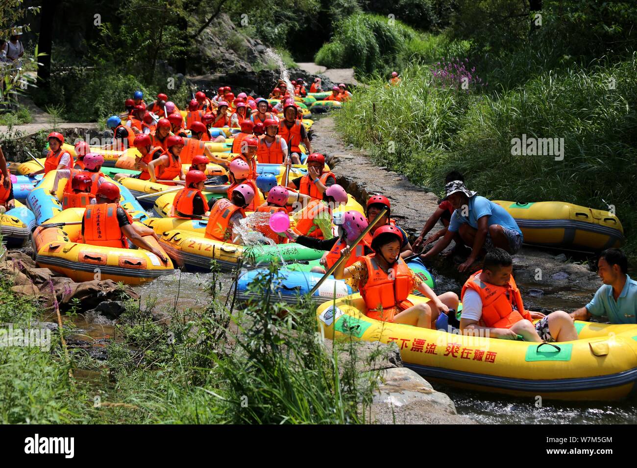 Tourists in life vests enjoy leisure time on rubber rafts at Grand ...