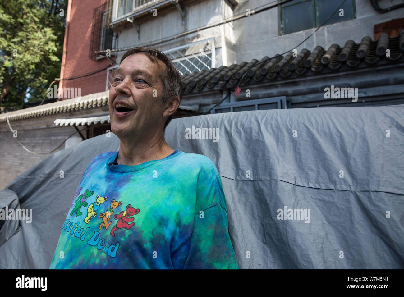 62-year-old American man Gao Tianrui with a red armband identifying the ...