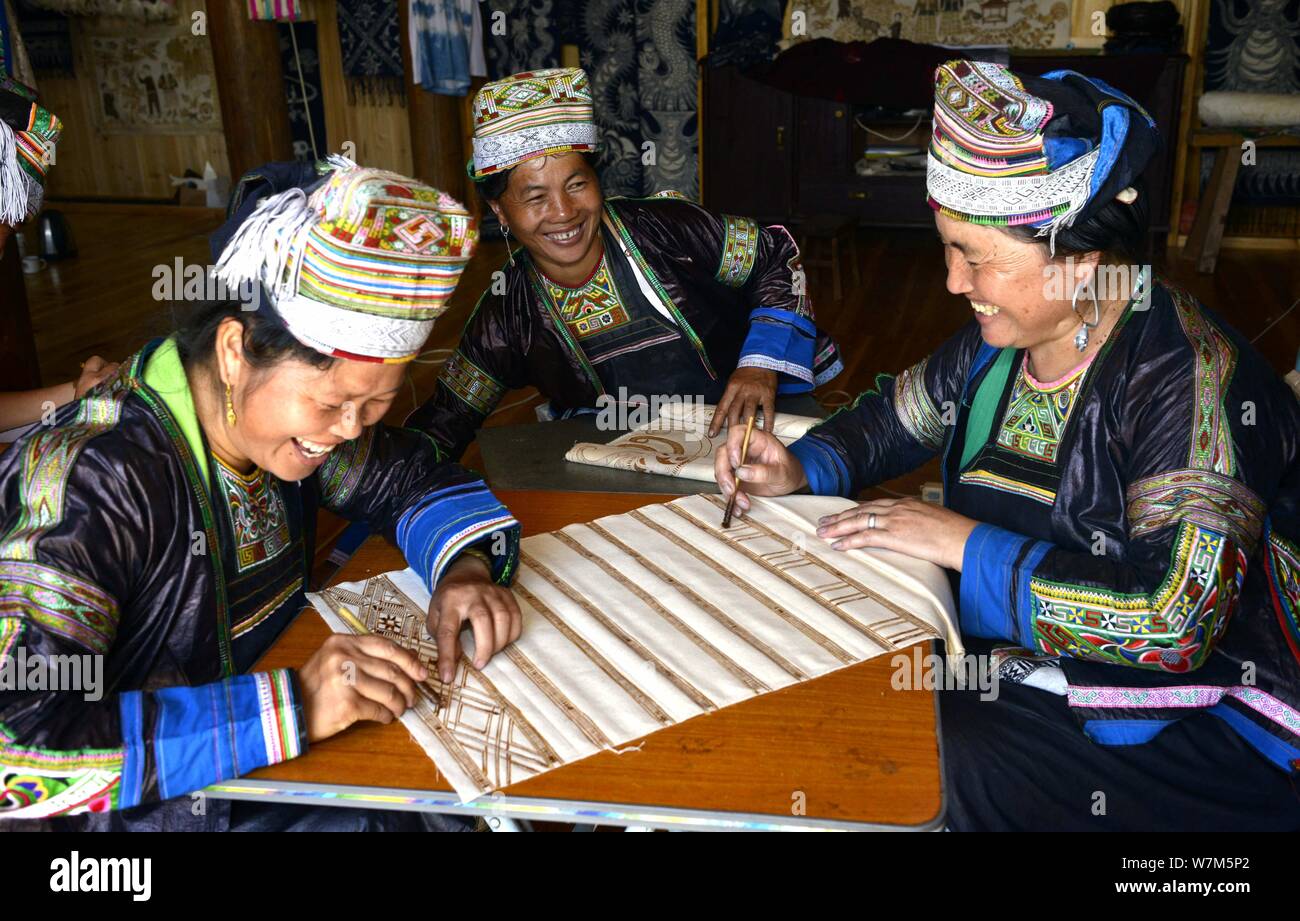 Chinese women of Miao ethnic group wearing traditional costumes make a ...