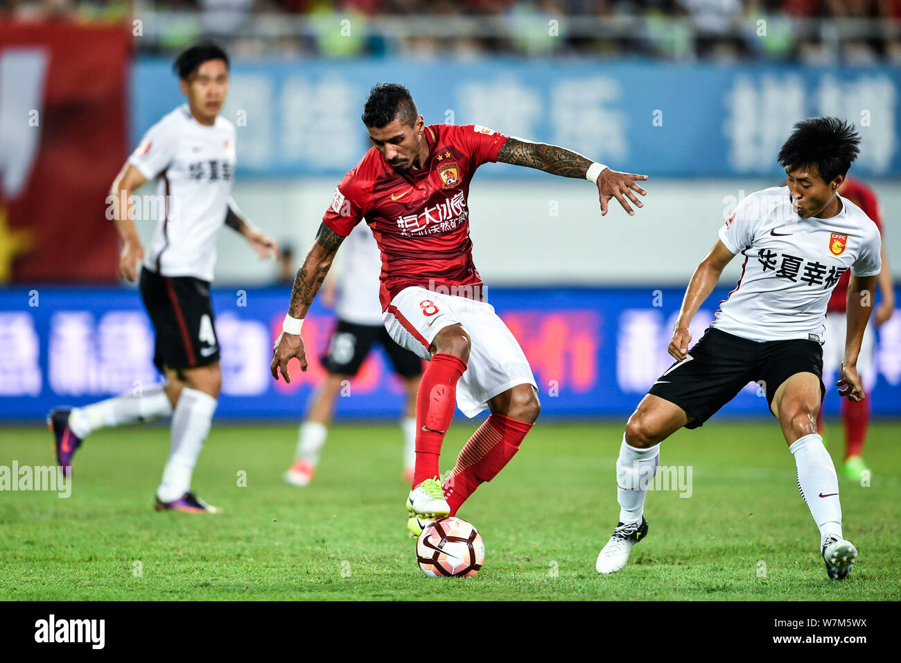 --FILE--Brazilian football player Paulinho, left, of Guangzhou ...