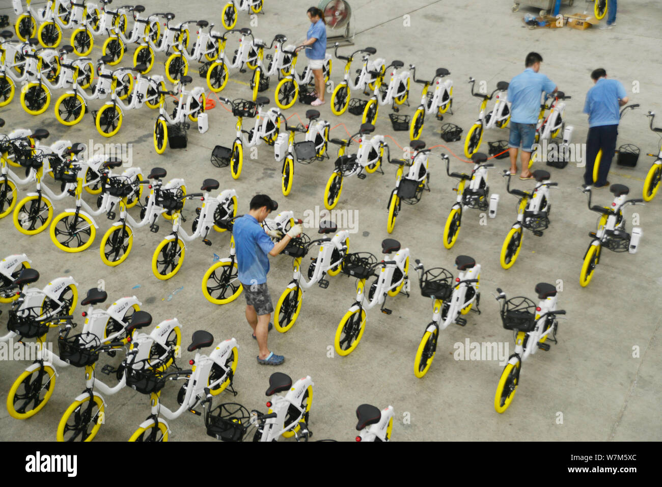 Chinese workers check smart shared bikes of Chinese bicycle maker ...