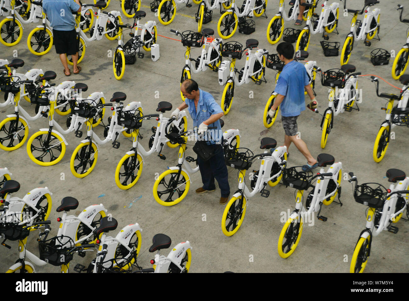 Chinese workers check smart shared bikes of Chinese bicycle maker ...