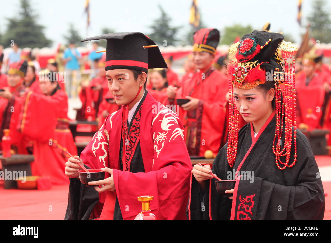 A couple of newlyweds dressed in traditional Han costumes takes part in ...