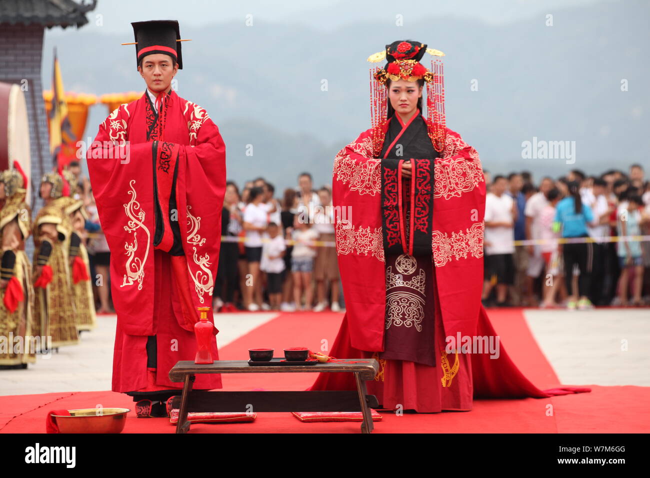 A couple of newlyweds dressed in traditional Han costumes takes part in ...