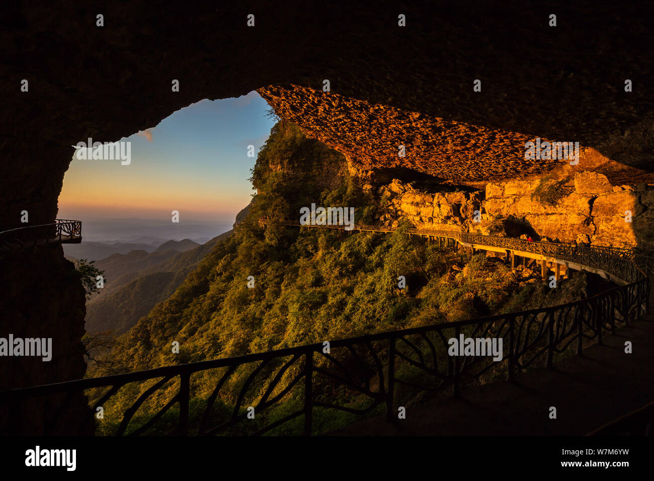 Landscape of sunset glow on a plank road built along the vertical cliff ...