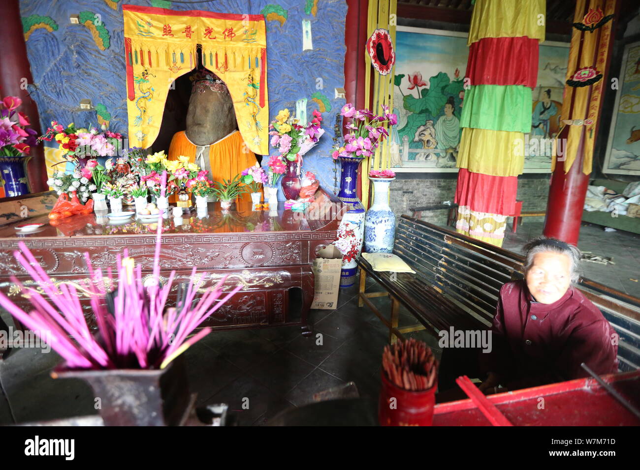 A local villager takes care of the statue of the Weaver Girl (Zhinv) in ...
