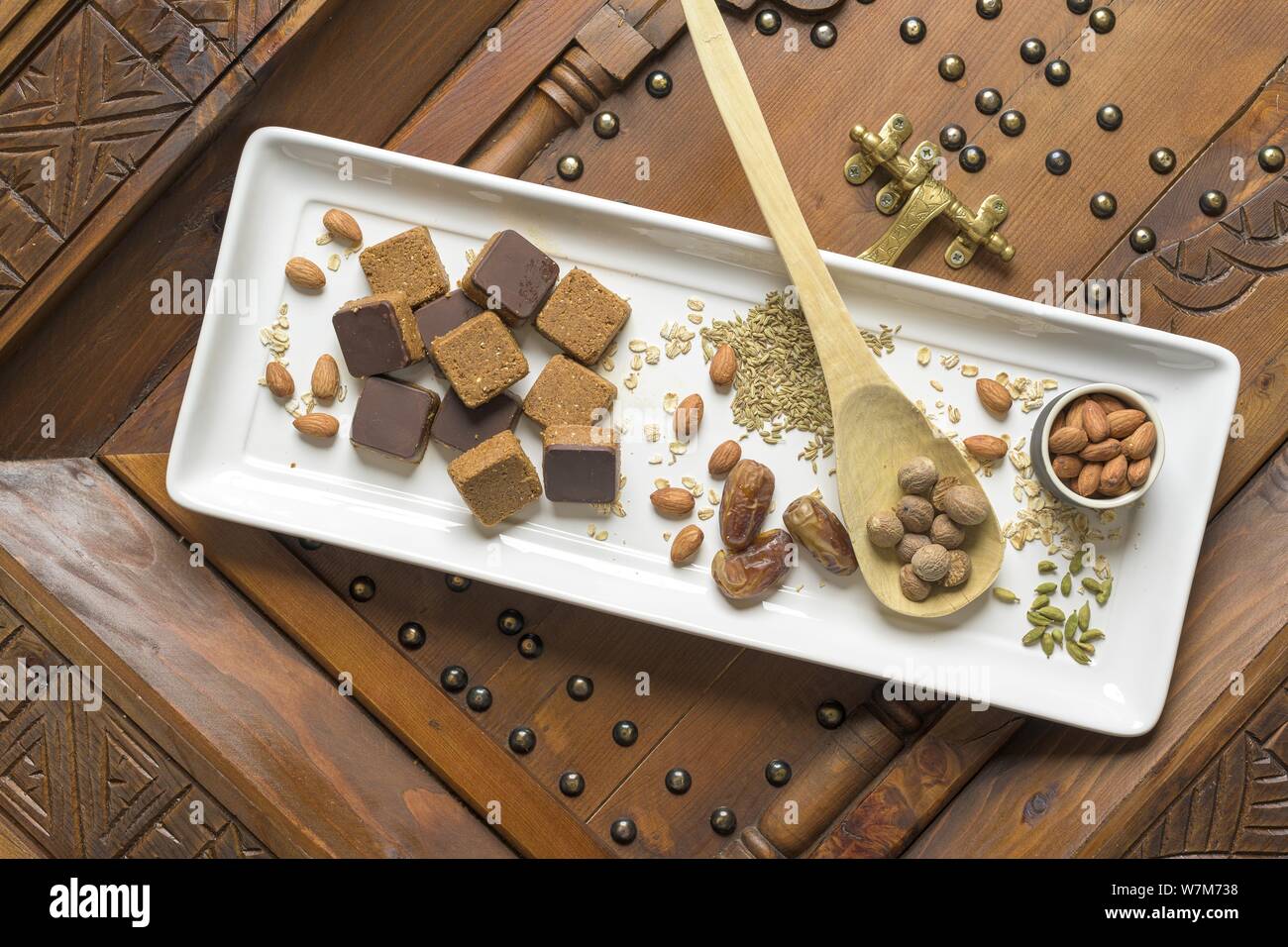 Overhead shot of different types of nuts and square-shaped nuts on a ...