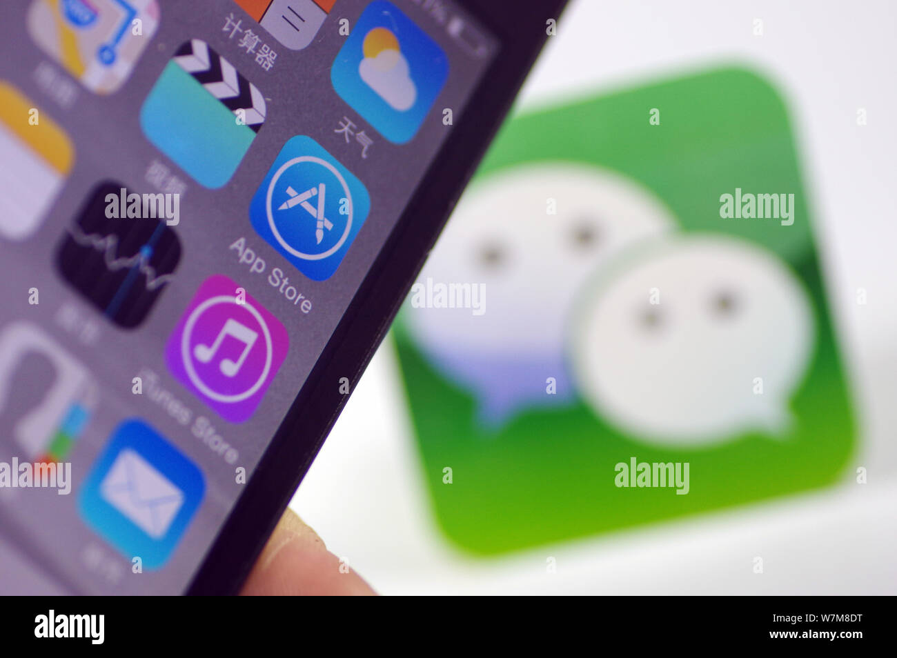 A Chinese mobile phone user shows the icons of App Store and other ...