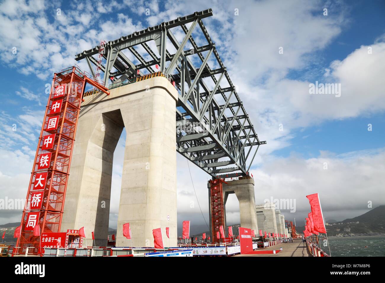 The first steel truss girder is pictured on the bridge piers of the ...