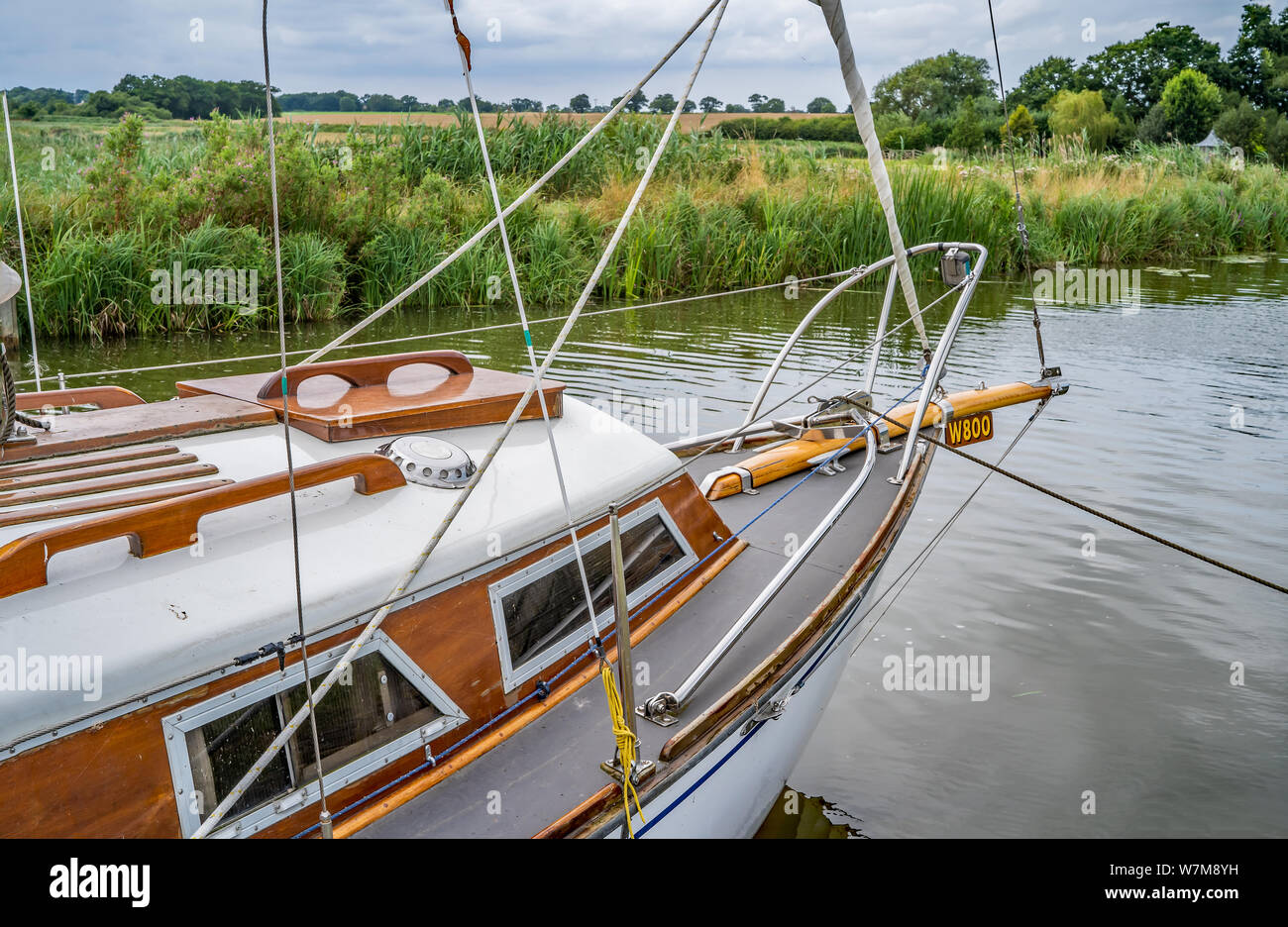 The front end (bow) of a traditional sailing boat moored to a wooden ...