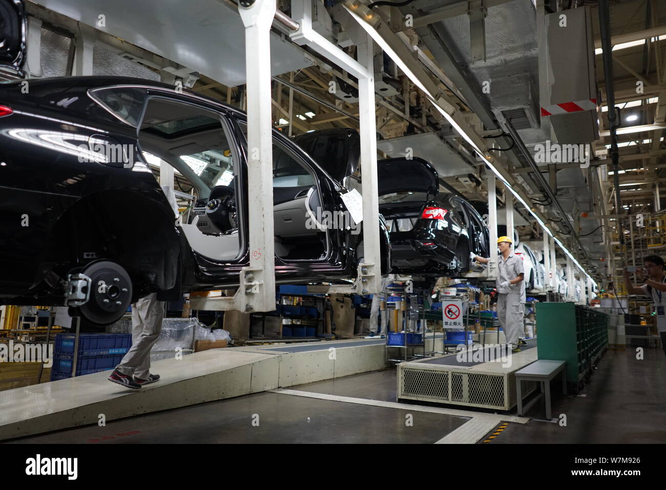 --FILE--Chinese workers assemble cars on the assembly line at an auto ...