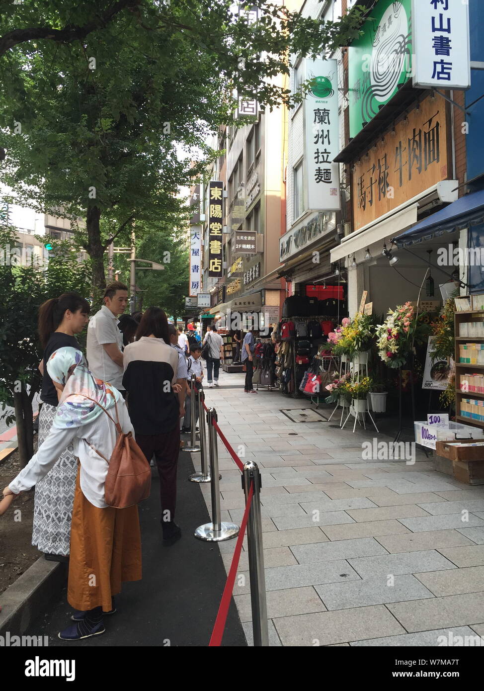 Japanese customers wait in line to enter a Lanzhou beef hand-pulled ...
