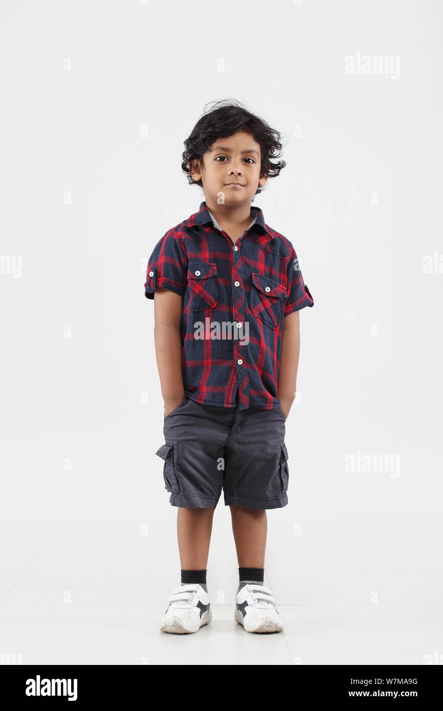Portrait of a boy standing with hands in pockets Stock Photo - Alamy
