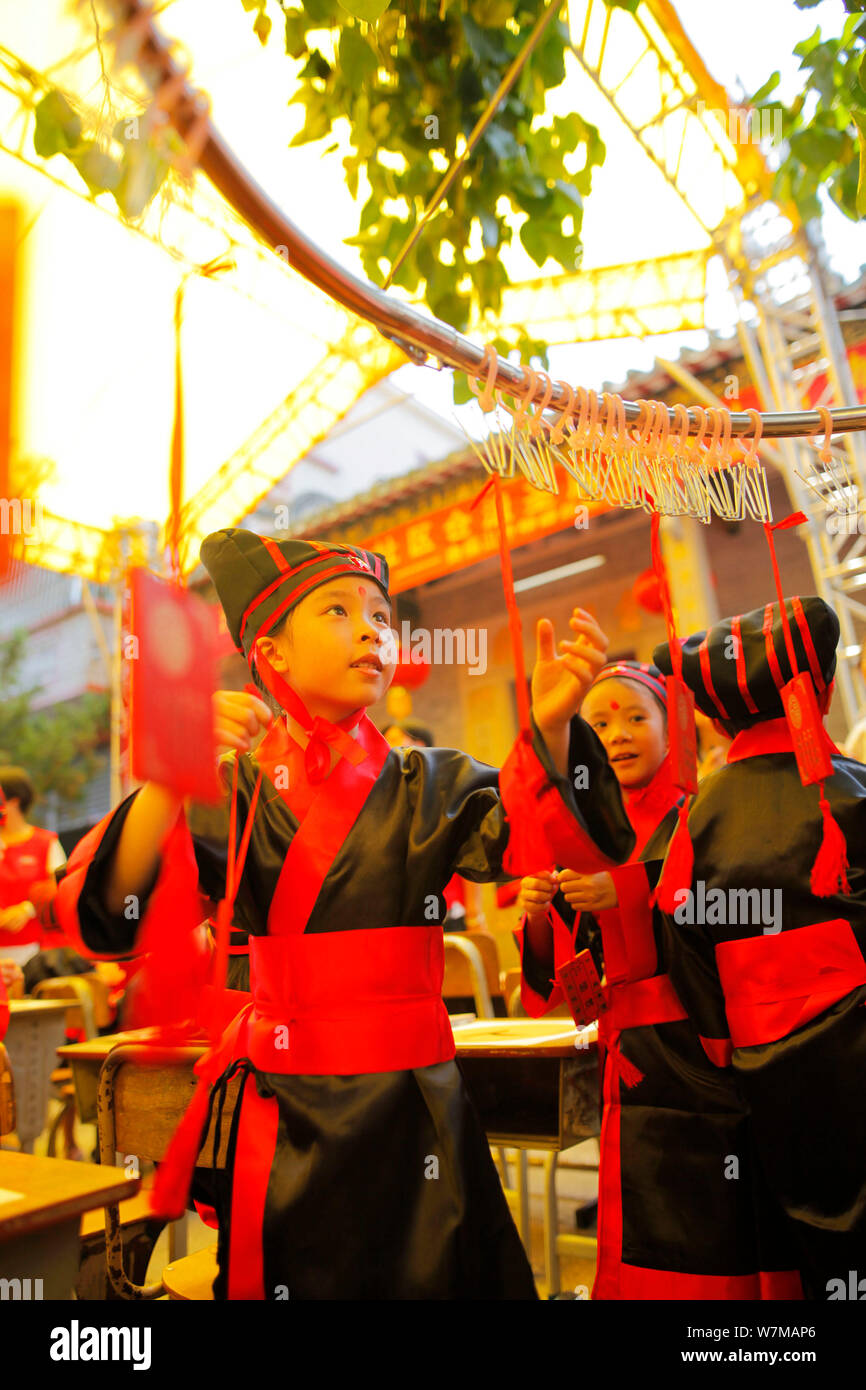A new first-grader makes wishes during a first writing ceremony in ...
