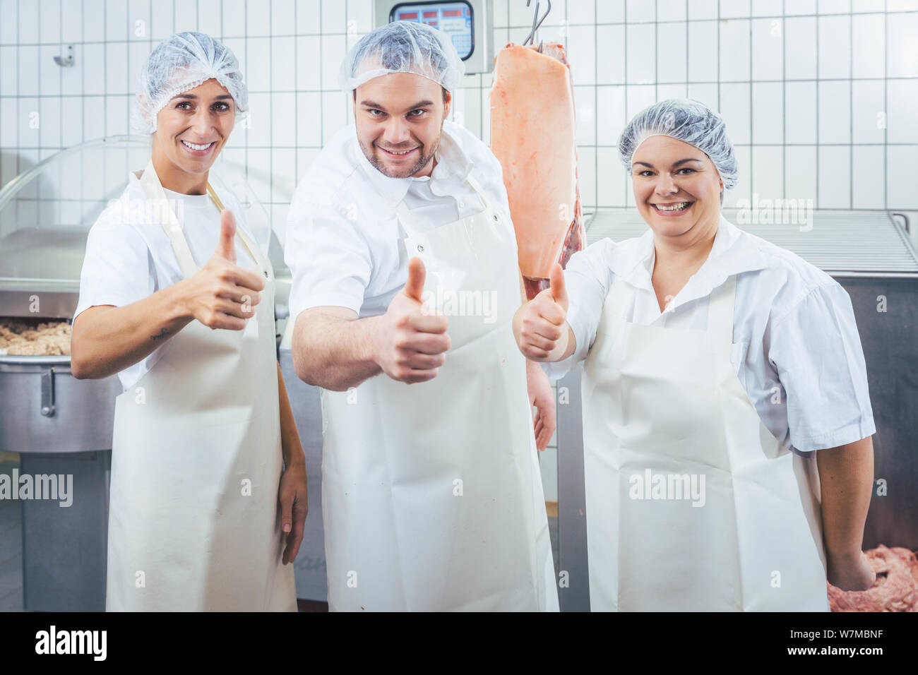 Team of butchers showing thumbs up Stock Photo - Alamy