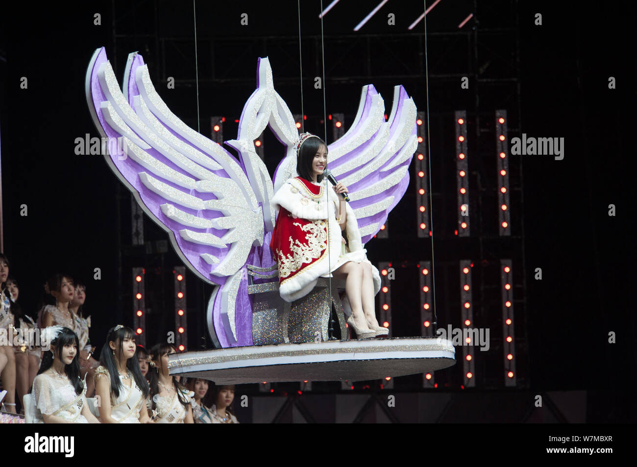 Winner Ju Jingyi of Chinese girl group SNH48 sitting on the champion ...