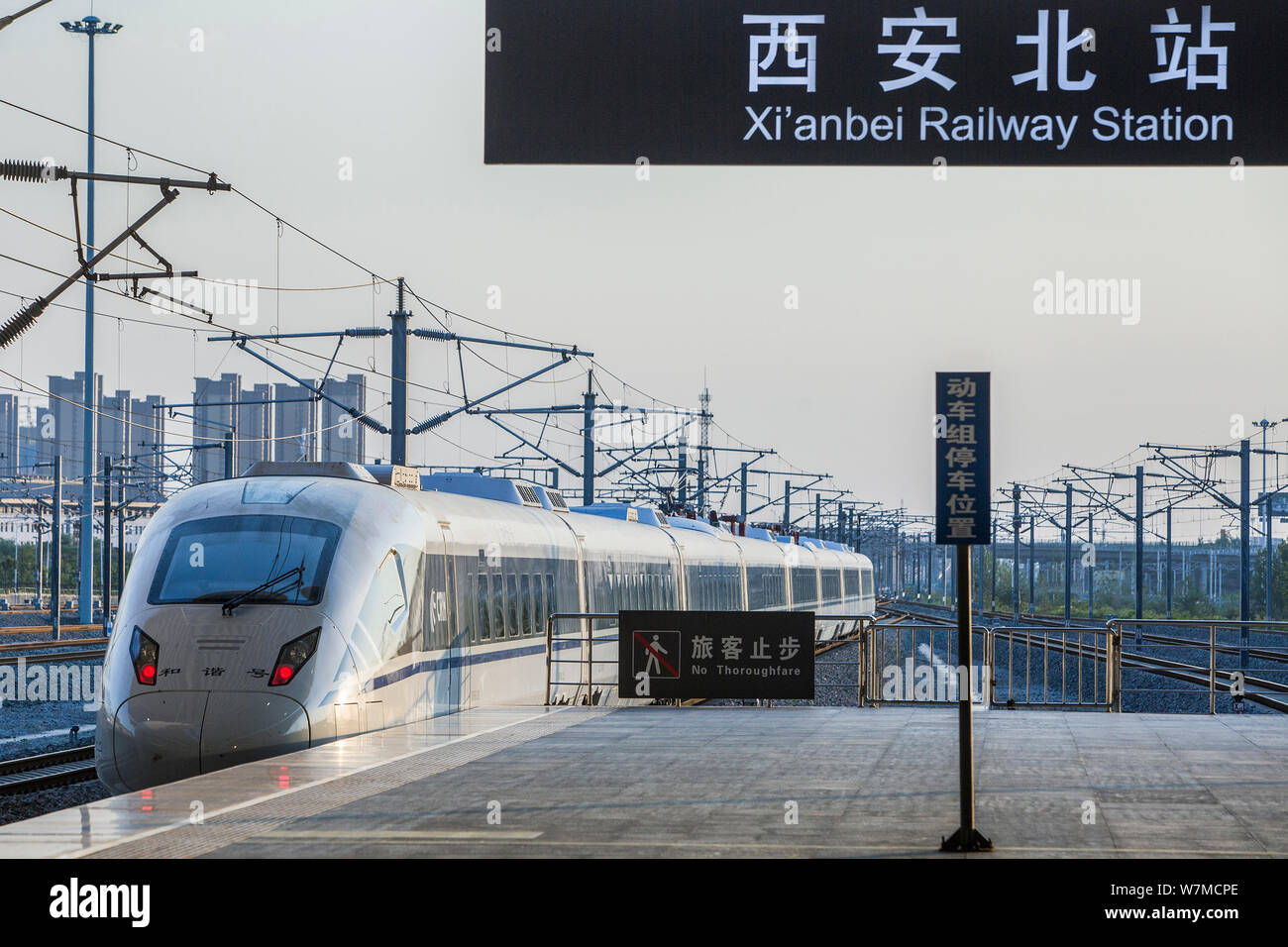 A CRH5G (China Railway High-speed) bullet train pulls out of the Xi ...