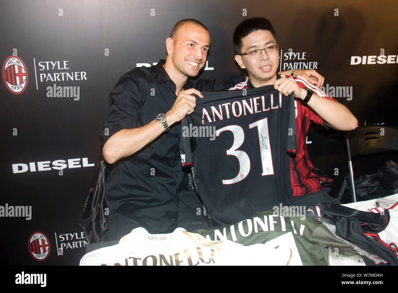 Italian football player Luca Antonelli of AC Milan, left, poses with a ...