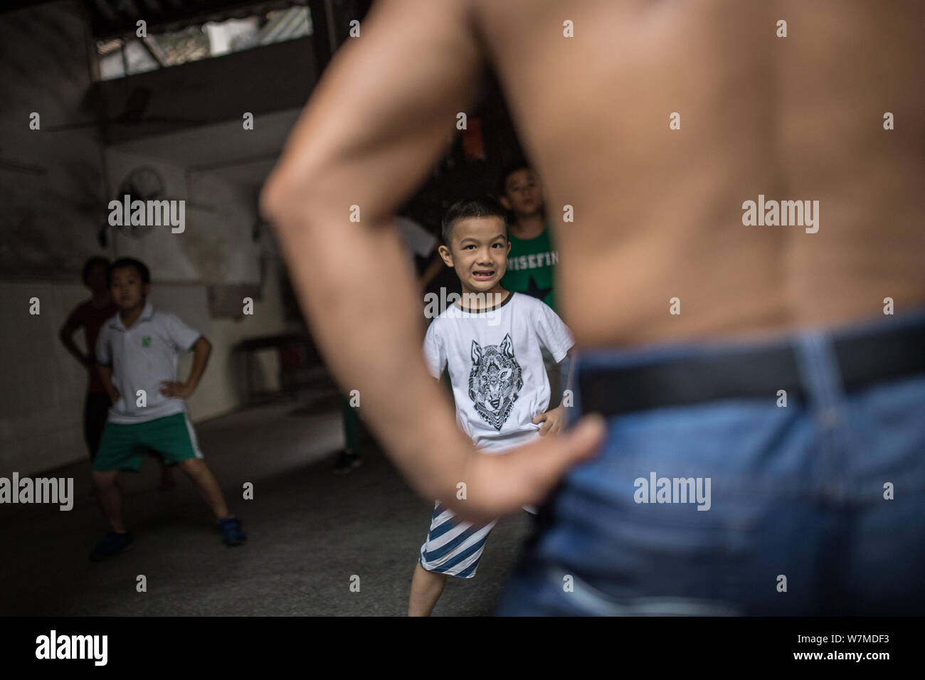 Chinese elementary schoolboys practice martial arts moves with kungfu ...