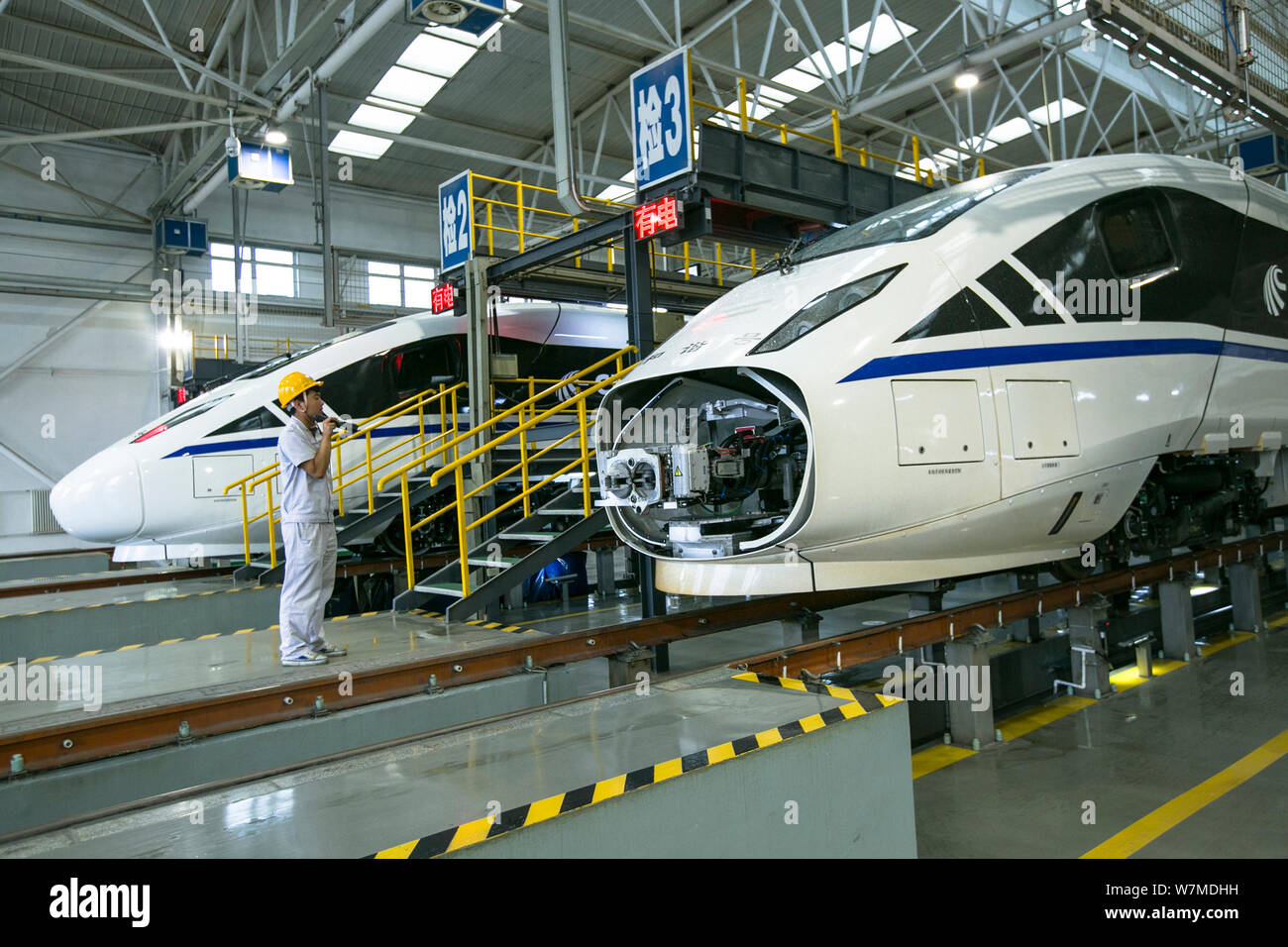 A Chinese worker checks a CRH5G (China Railway High-speed) bullet train ...