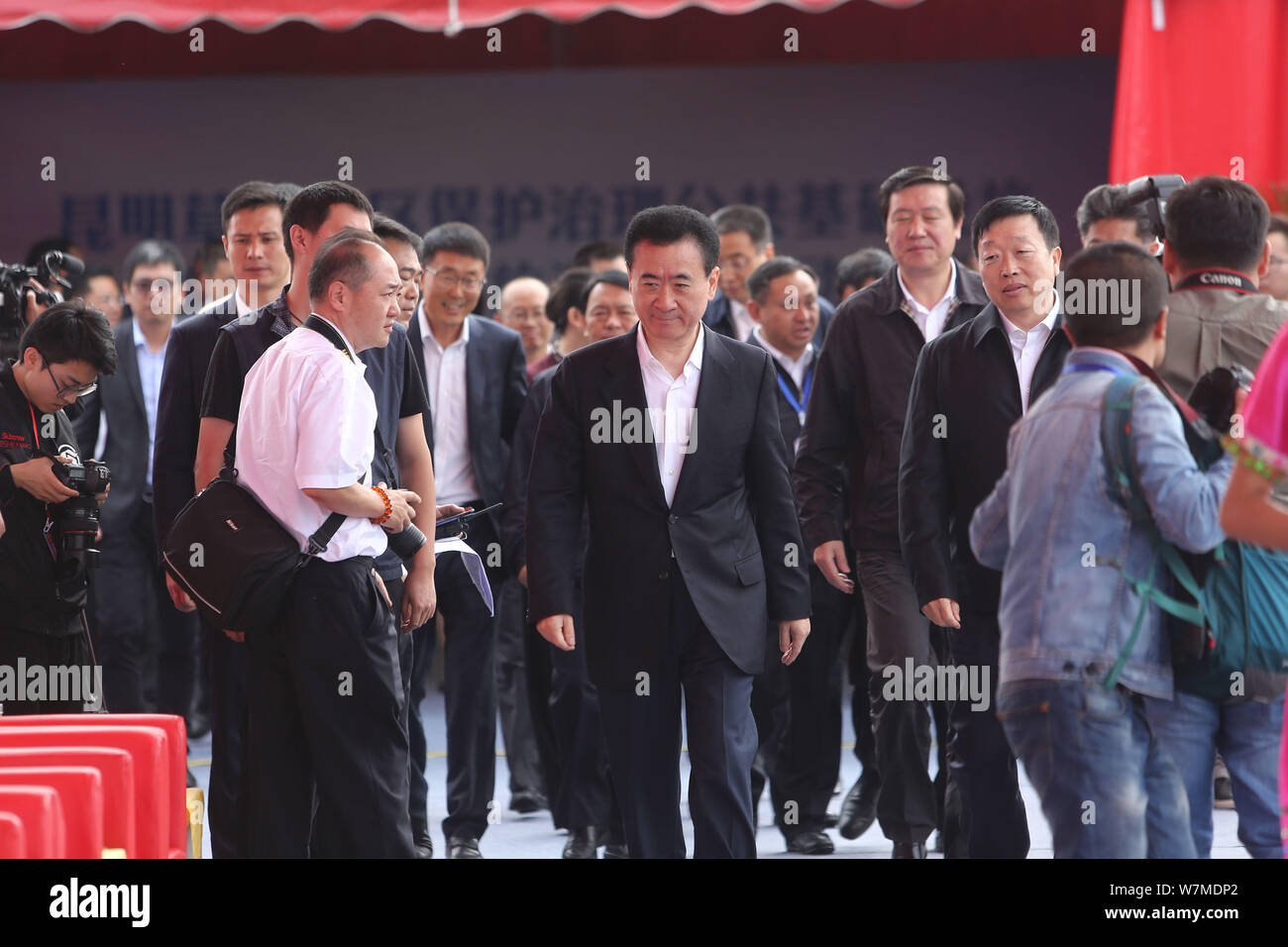 Wang Jianlin, center, Chairman of Dalian Wanda Group, attends the ...