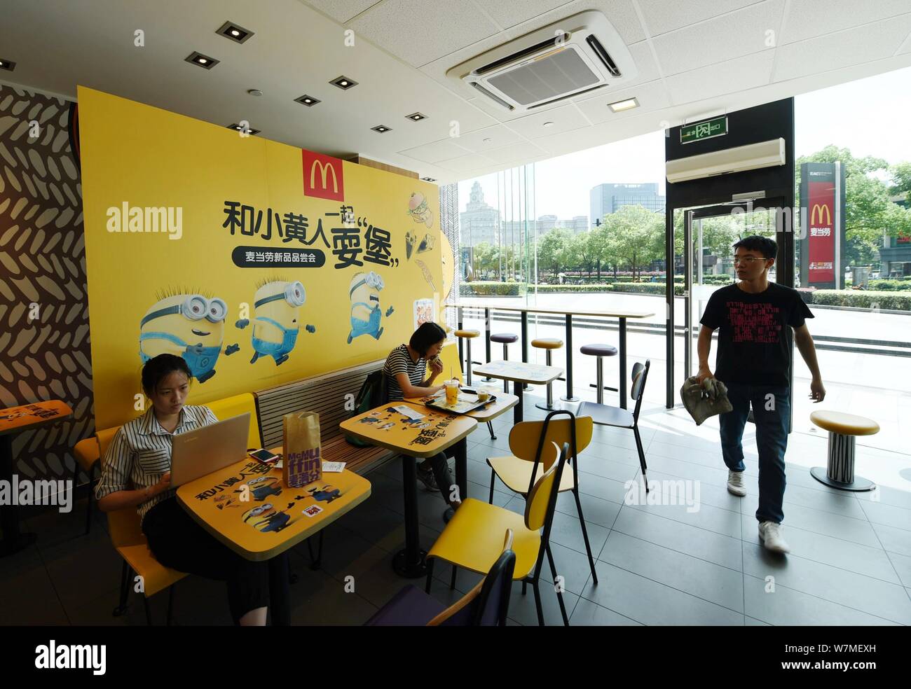Customers eat food at a Minions-themed fastfood restaurant of McDonald ...