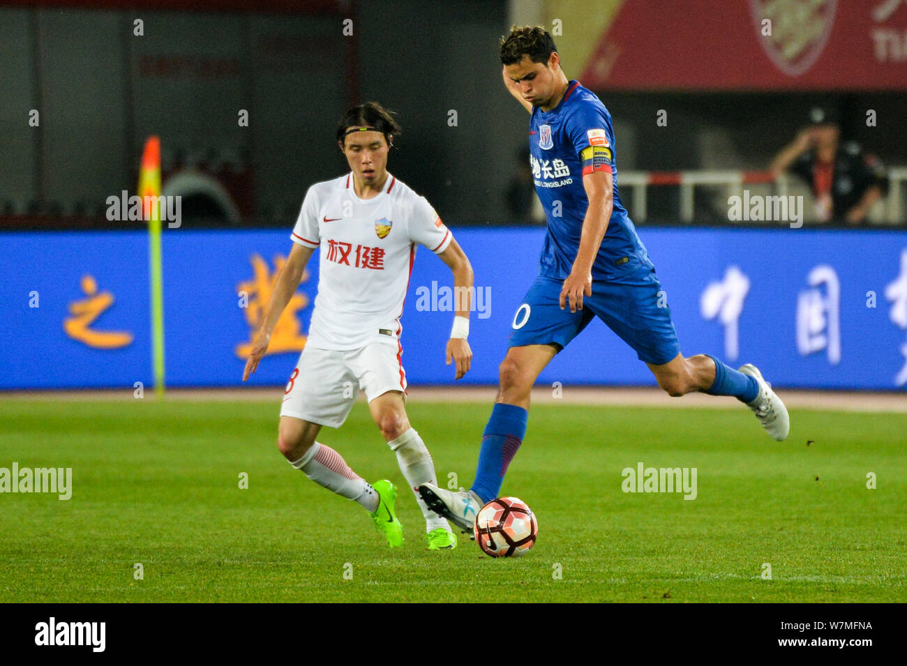 Colombian football player Giovanni Moreno, right, of Shanghai Greenland ...