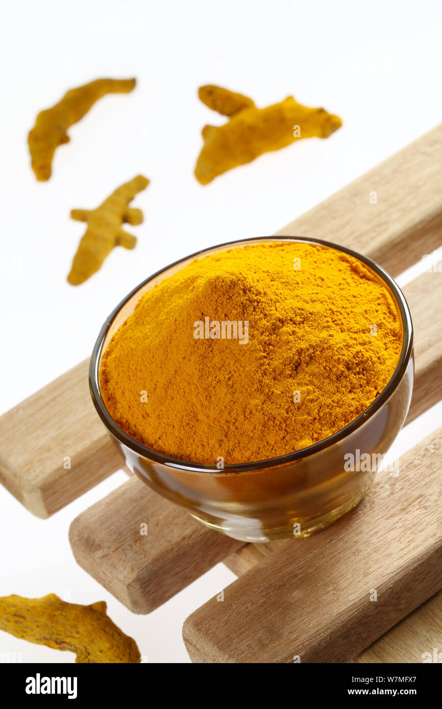 Bowl full of turmeric powder on the edge of bench Stock Photo - Alamy