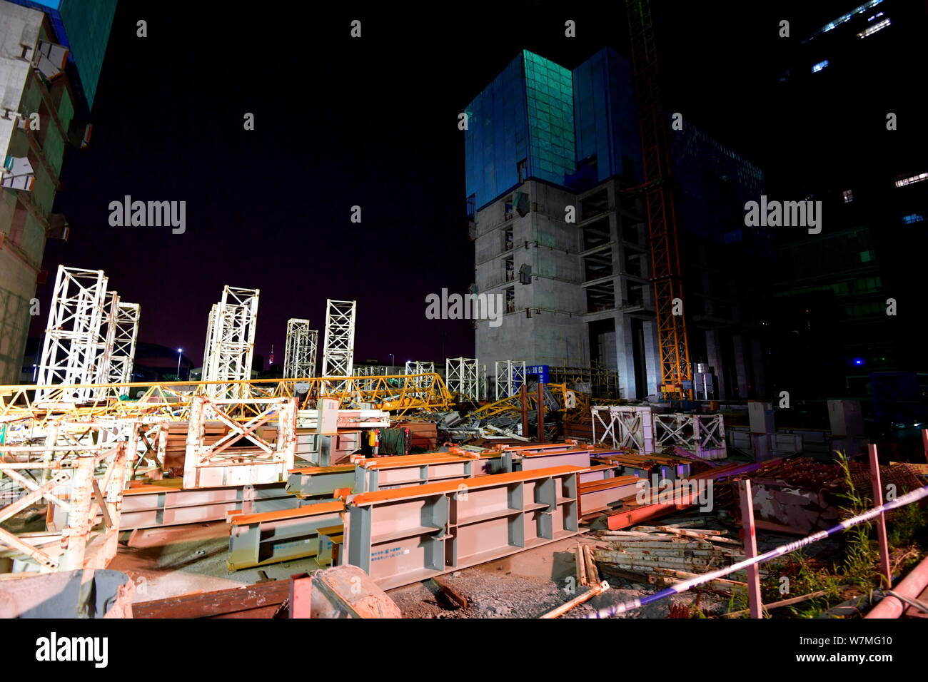 The deformed steel structure of a collapsed tower crane is seen at a ...