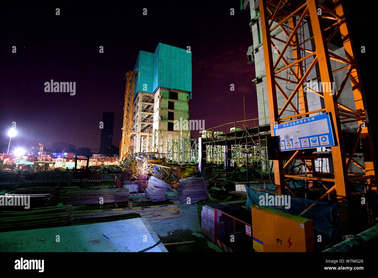 The deformed steel structure of a collapsed tower crane is seen at a ...