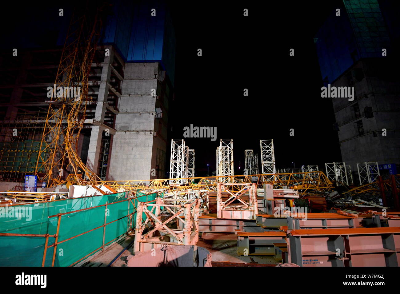 The deformed steel structure of a collapsed tower crane is seen at a ...