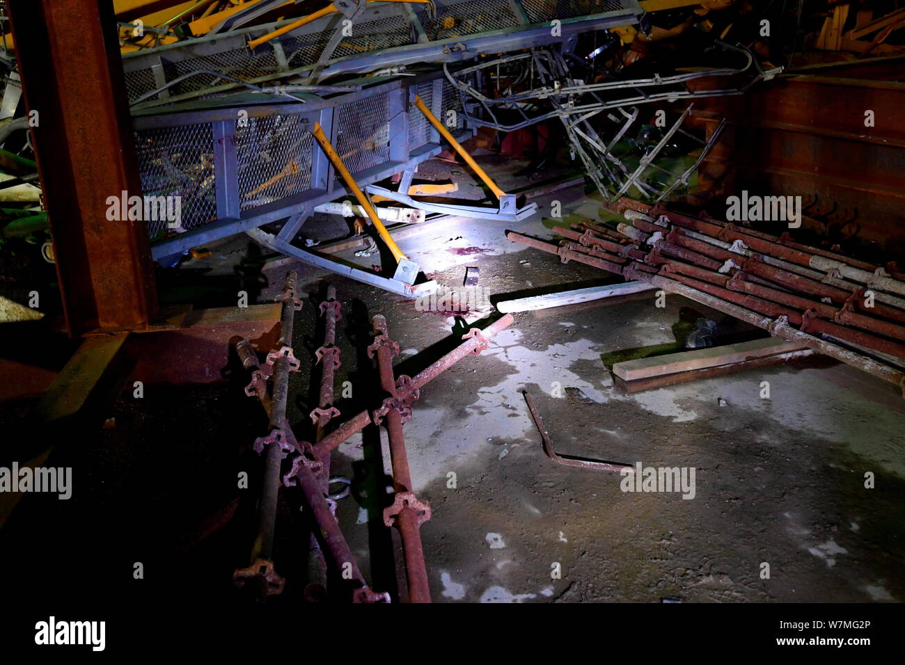 The deformed steel structure of a collapsed tower crane is seen at a ...