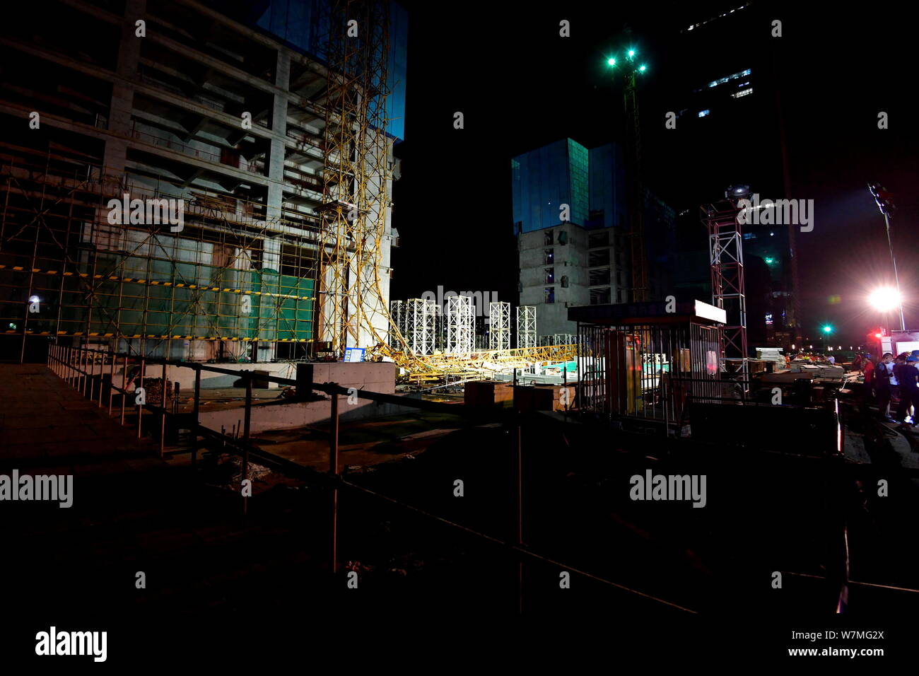 The deformed steel structure of a collapsed tower crane is seen at a ...