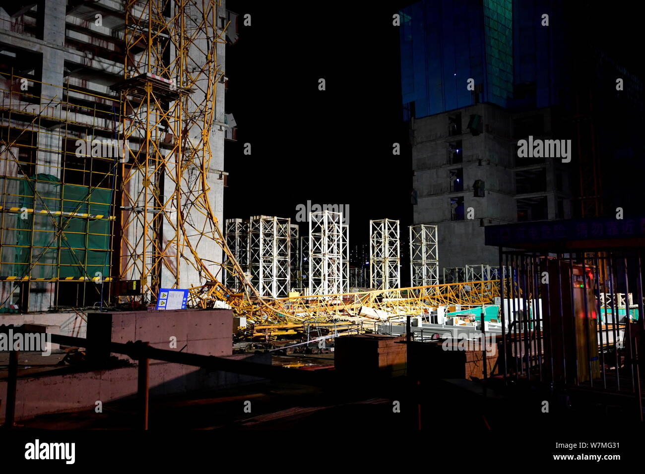 The deformed steel structure of a collapsed tower crane is seen at a ...