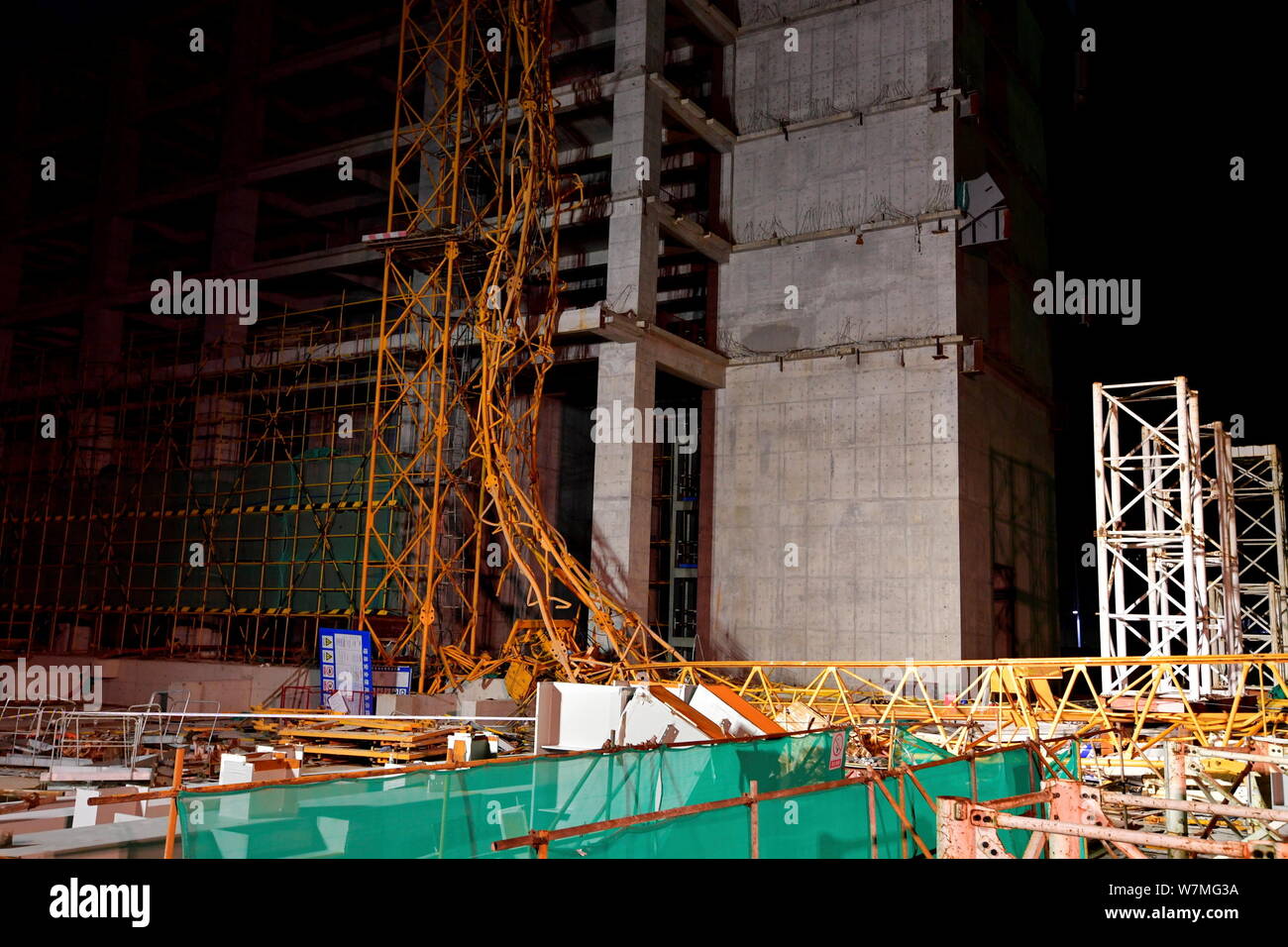 The deformed steel structure of a collapsed tower crane is seen at a ...